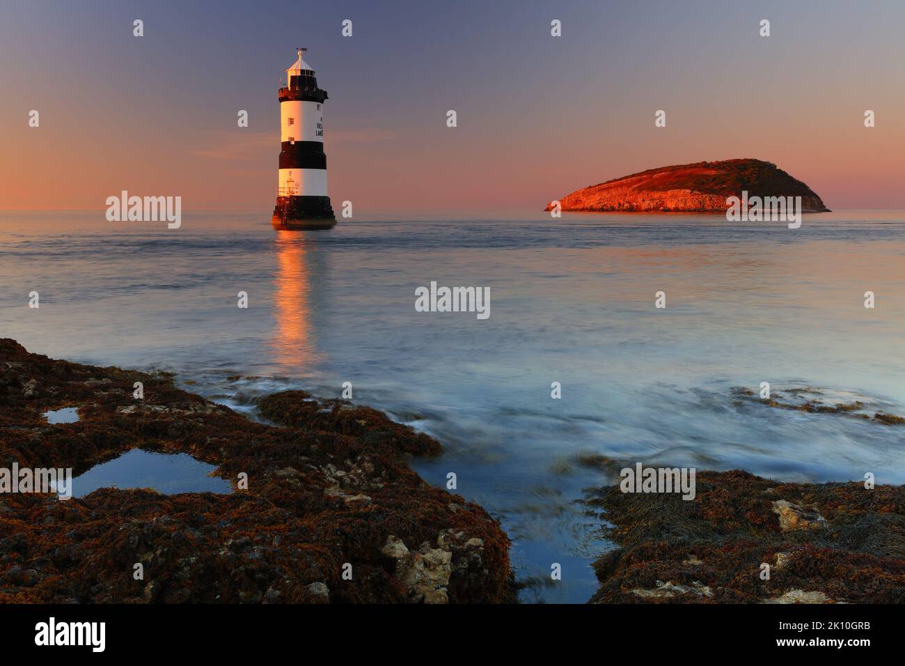 Penmon Point Lighthouse at Sunset with Puffin Island in the background ...