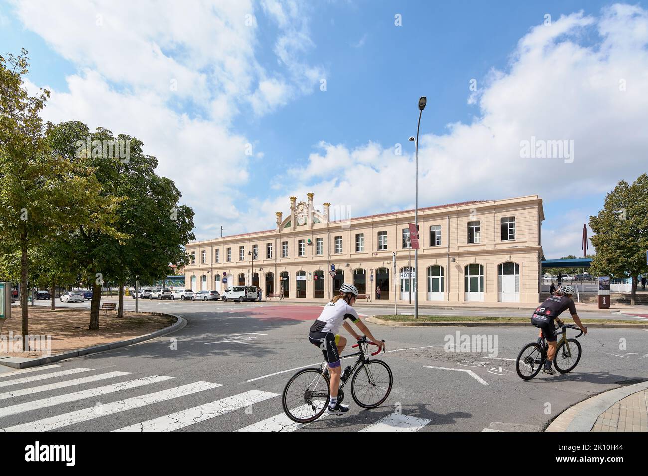 Vic, Spain - September 11, 2022: A man and a woman on bicycles, passing ...