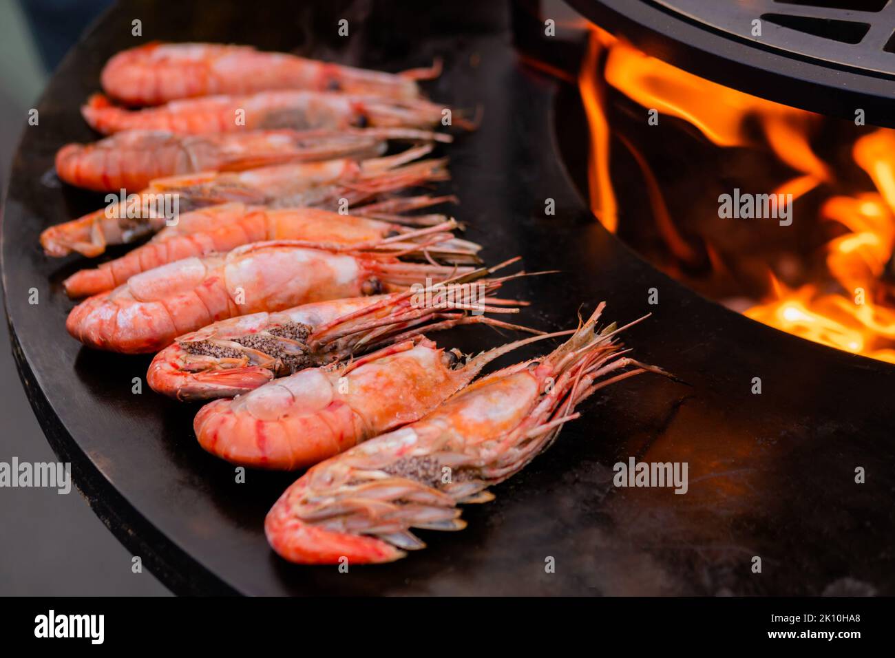 Process of cooking fresh red langoustine shrimps, prawns on grill ...