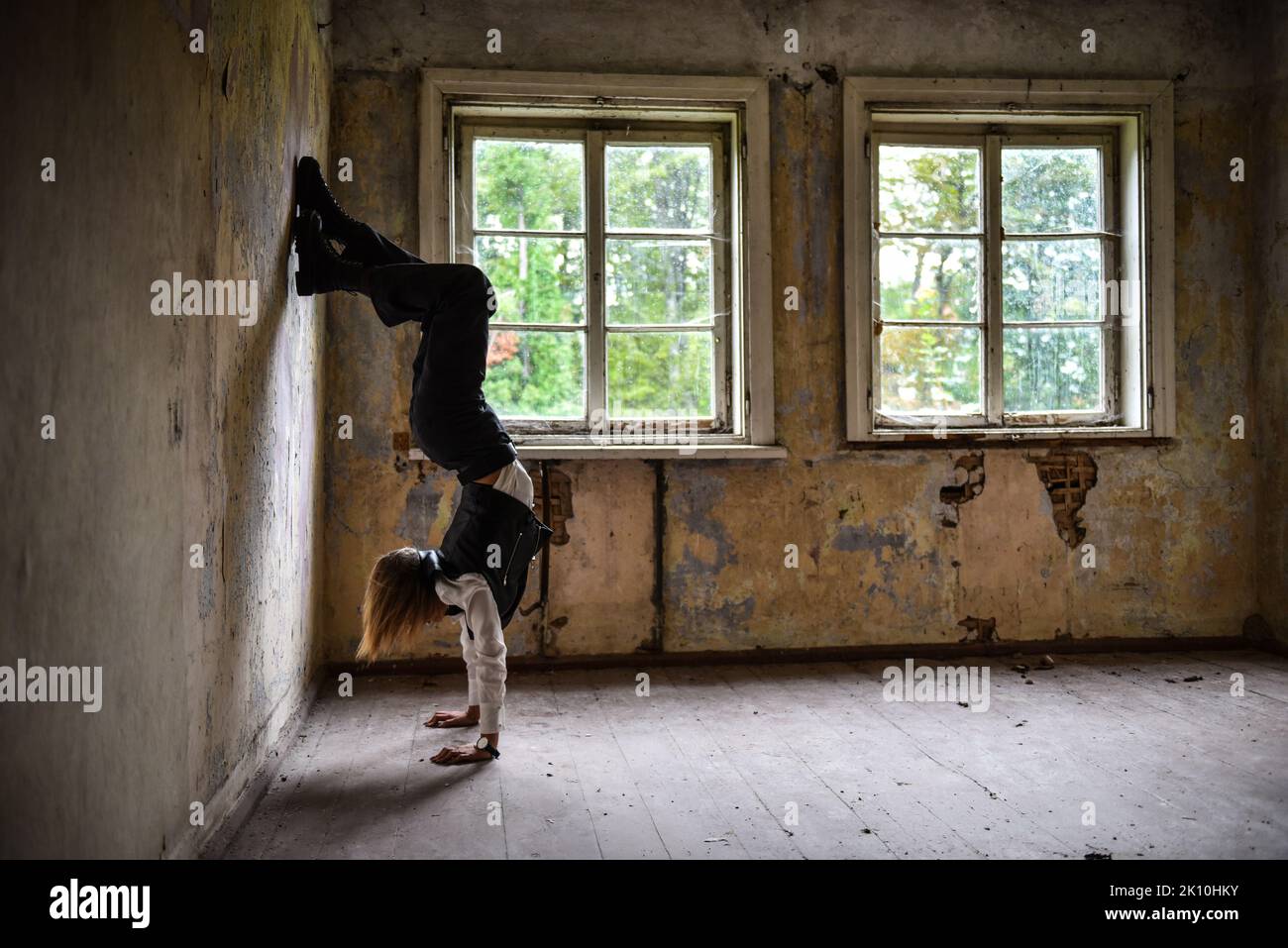 Choreographer girl doing an exercise in an old room of an abandoned ...