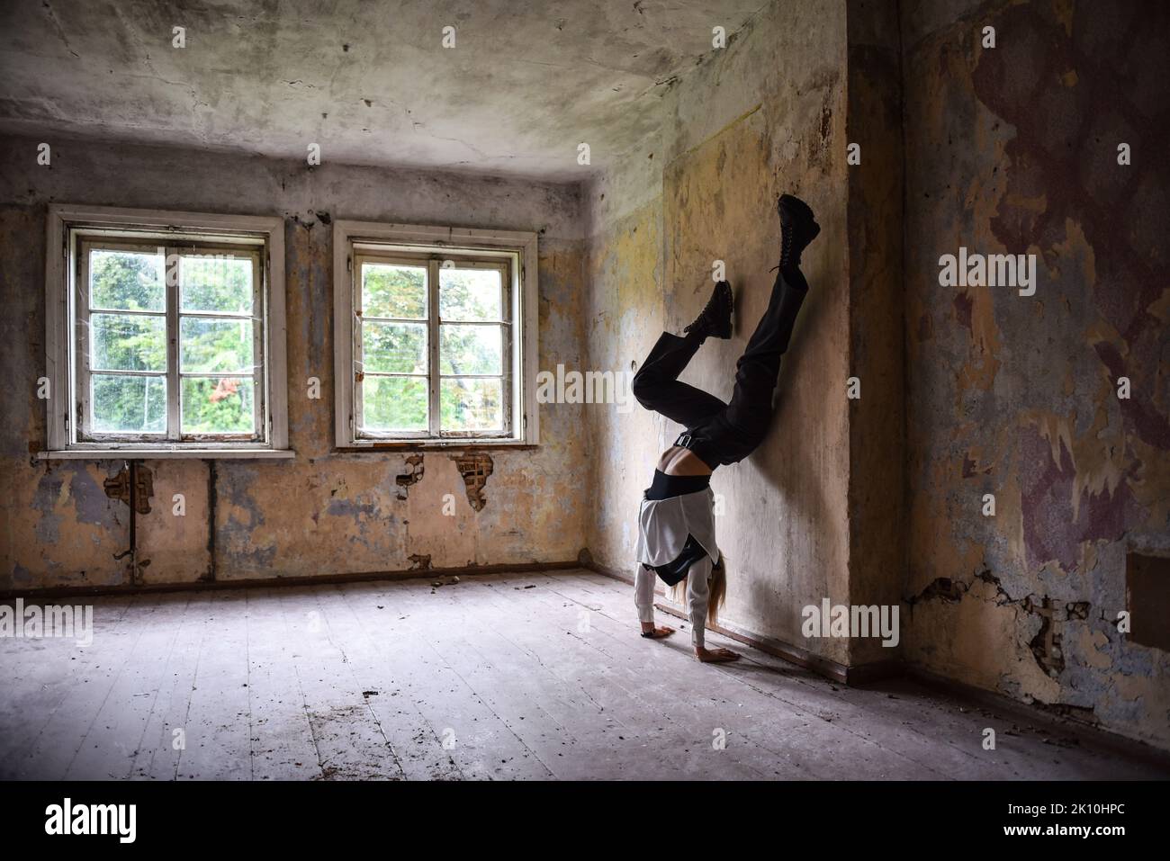 Choreographer girl doing an exercise in an old room of an abandoned ...