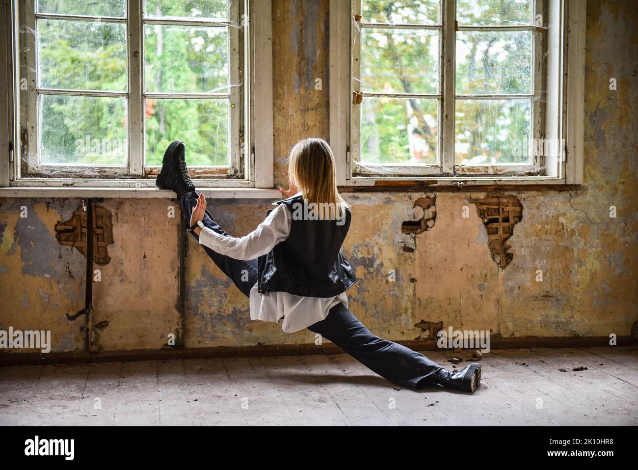 Choreographer girl doing an exercise in an old room of an abandoned ...