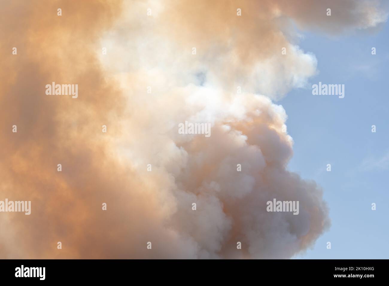 Cloud of smoke from large forest fire passing in front of sun ...