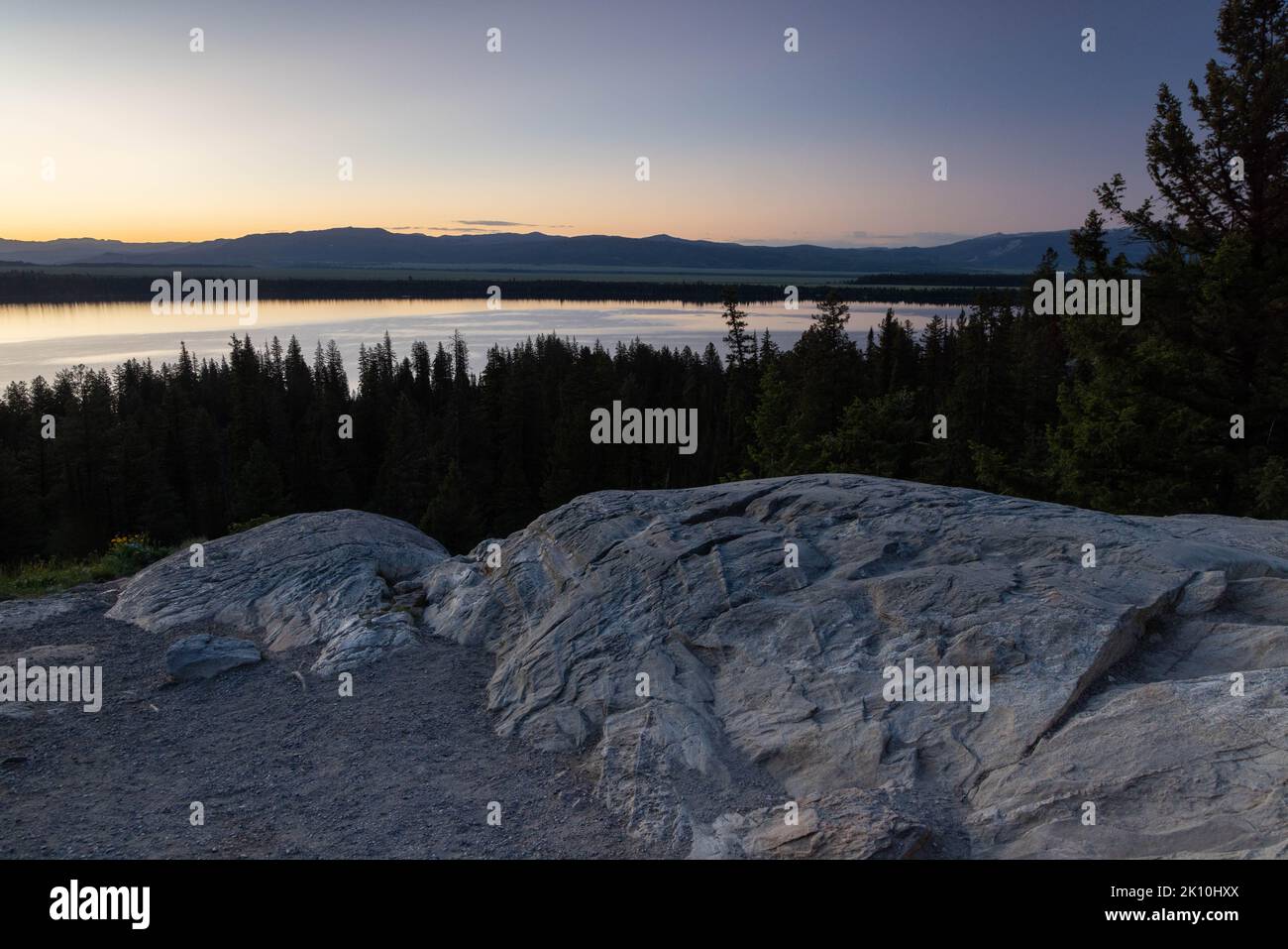 Large slabs of rock extending along an overlook toward Jenny Lake at ...