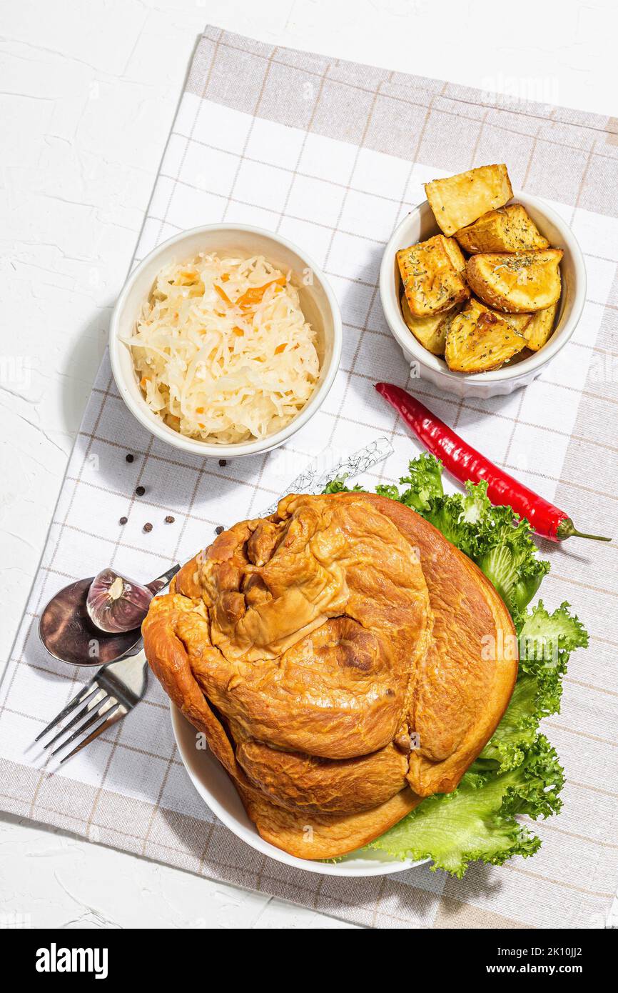 Traditional Oktoberfest smoked pork knuckle eisbein, fermented sour ...