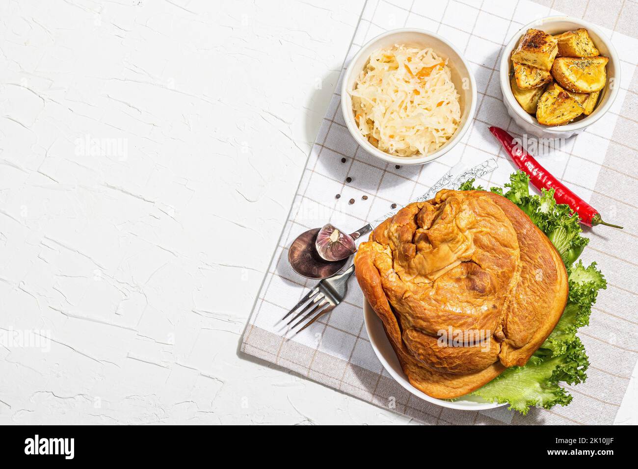 Traditional Oktoberfest smoked pork knuckle eisbein, fermented sour ...