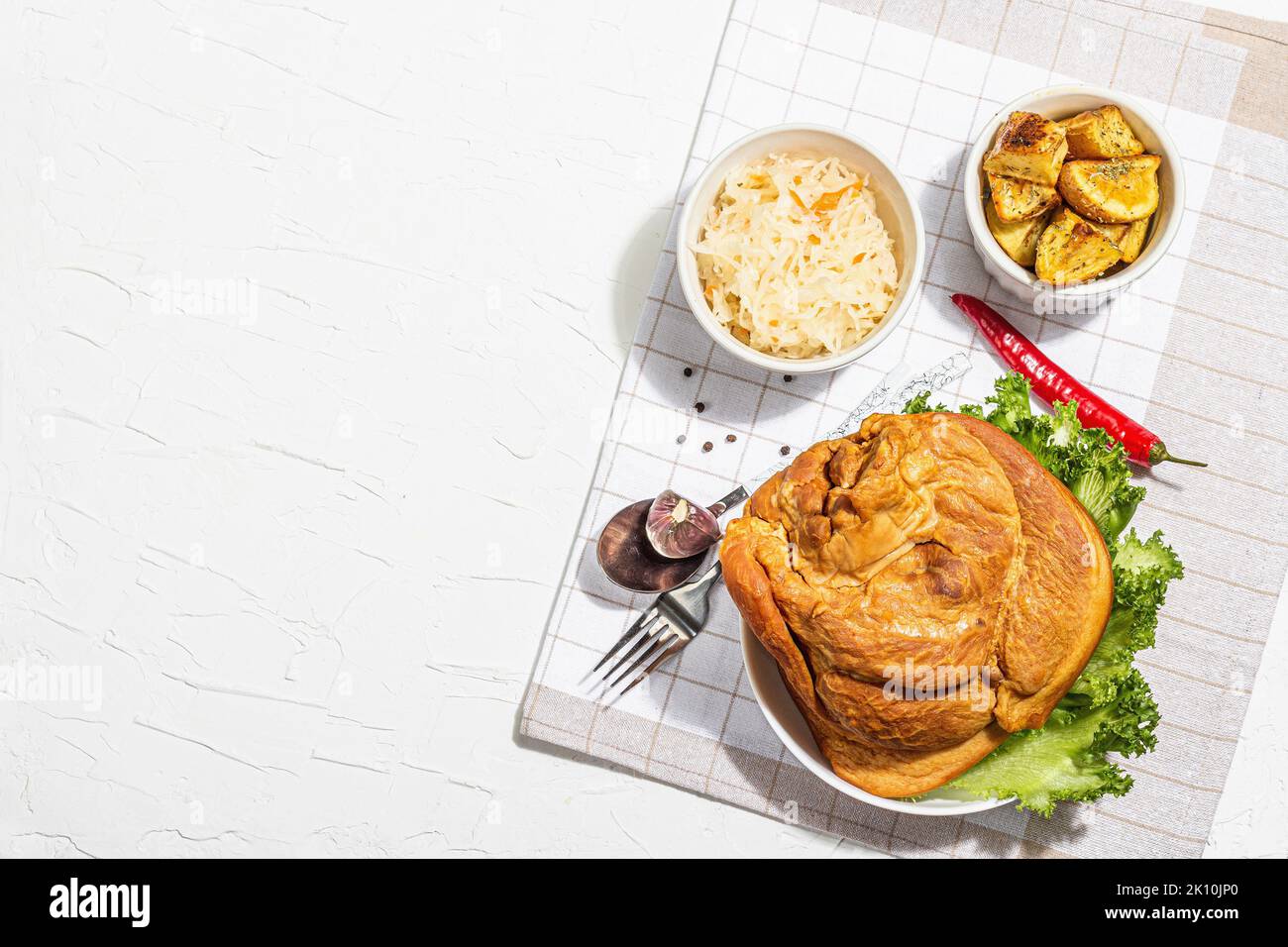 Traditional Oktoberfest smoked pork knuckle eisbein, fermented sour ...