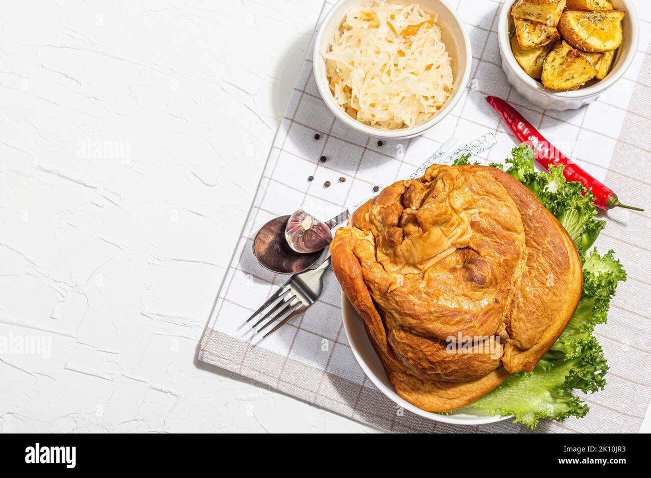 Traditional Oktoberfest smoked pork knuckle eisbein, fermented sour ...