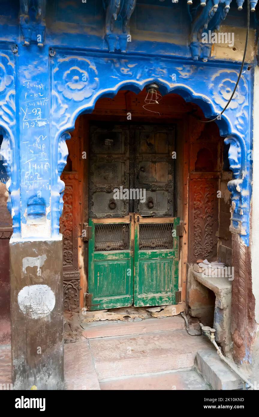 Traditional wooden door and blue coloured house of Jodhpur city ...