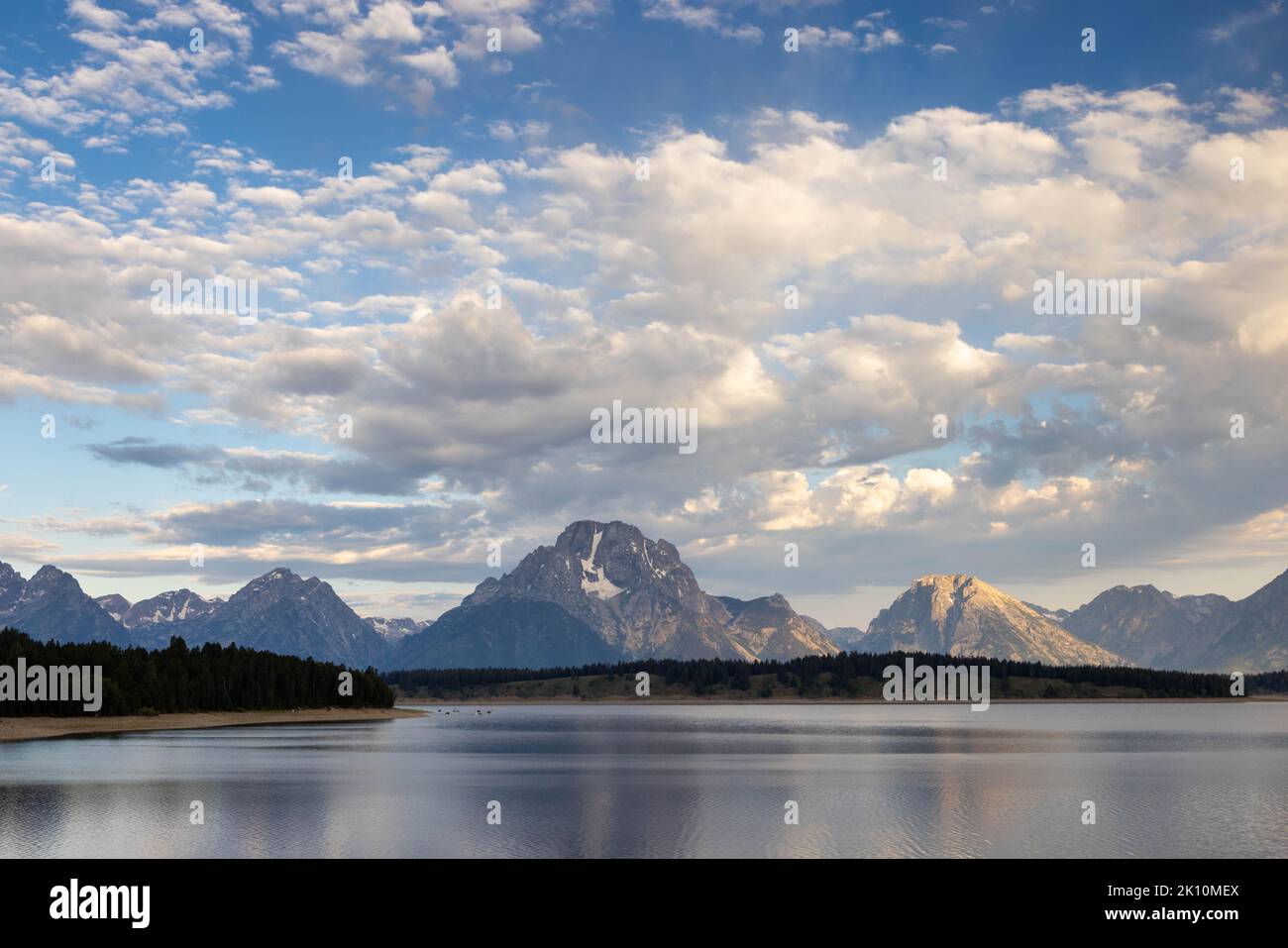 Early morning clouds lit with sunrise light clearing from Mount Moran ...