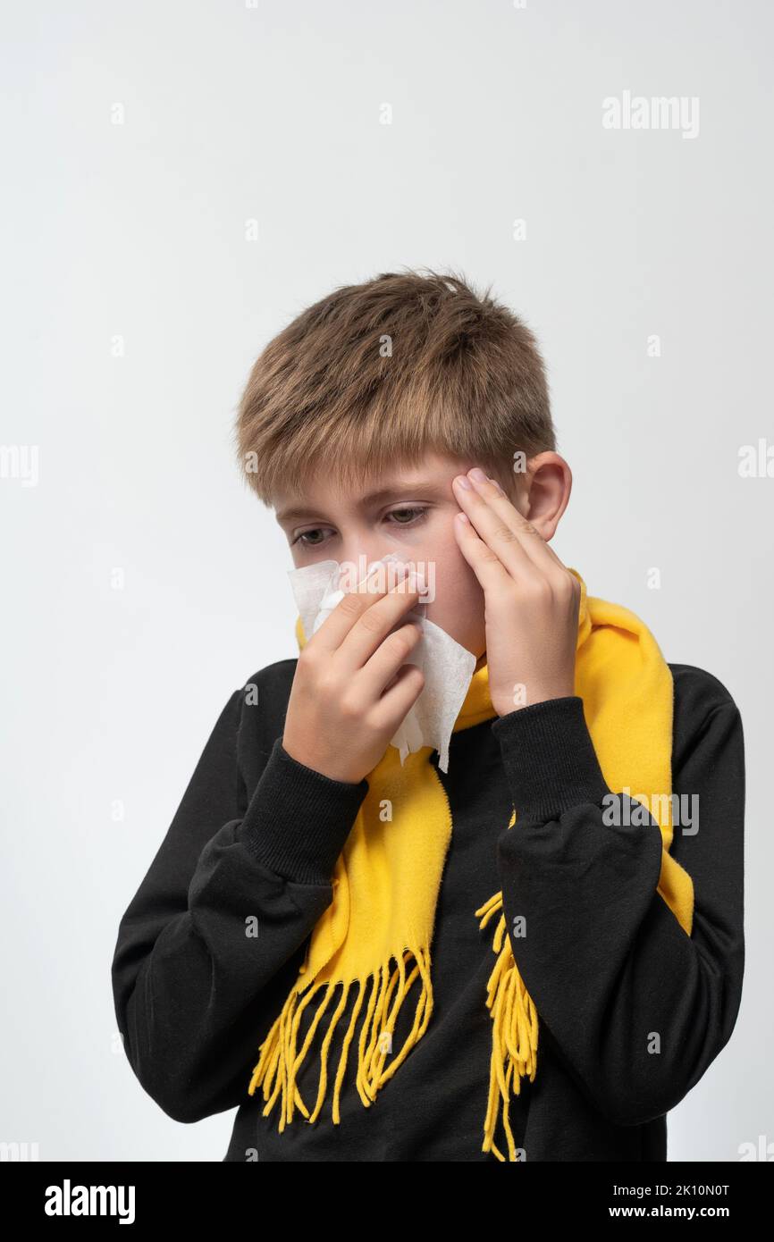 A child blows his nose into a napkin, children's seasonal diseases, a ...