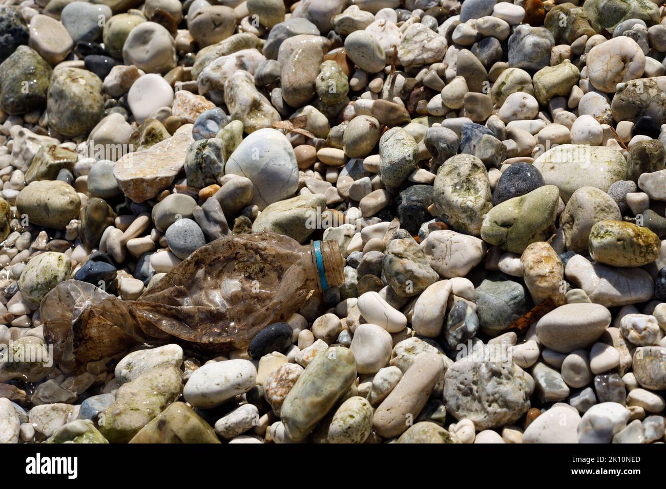 Old plastic bottle debris on the rock beach, marine pollution Stock ...