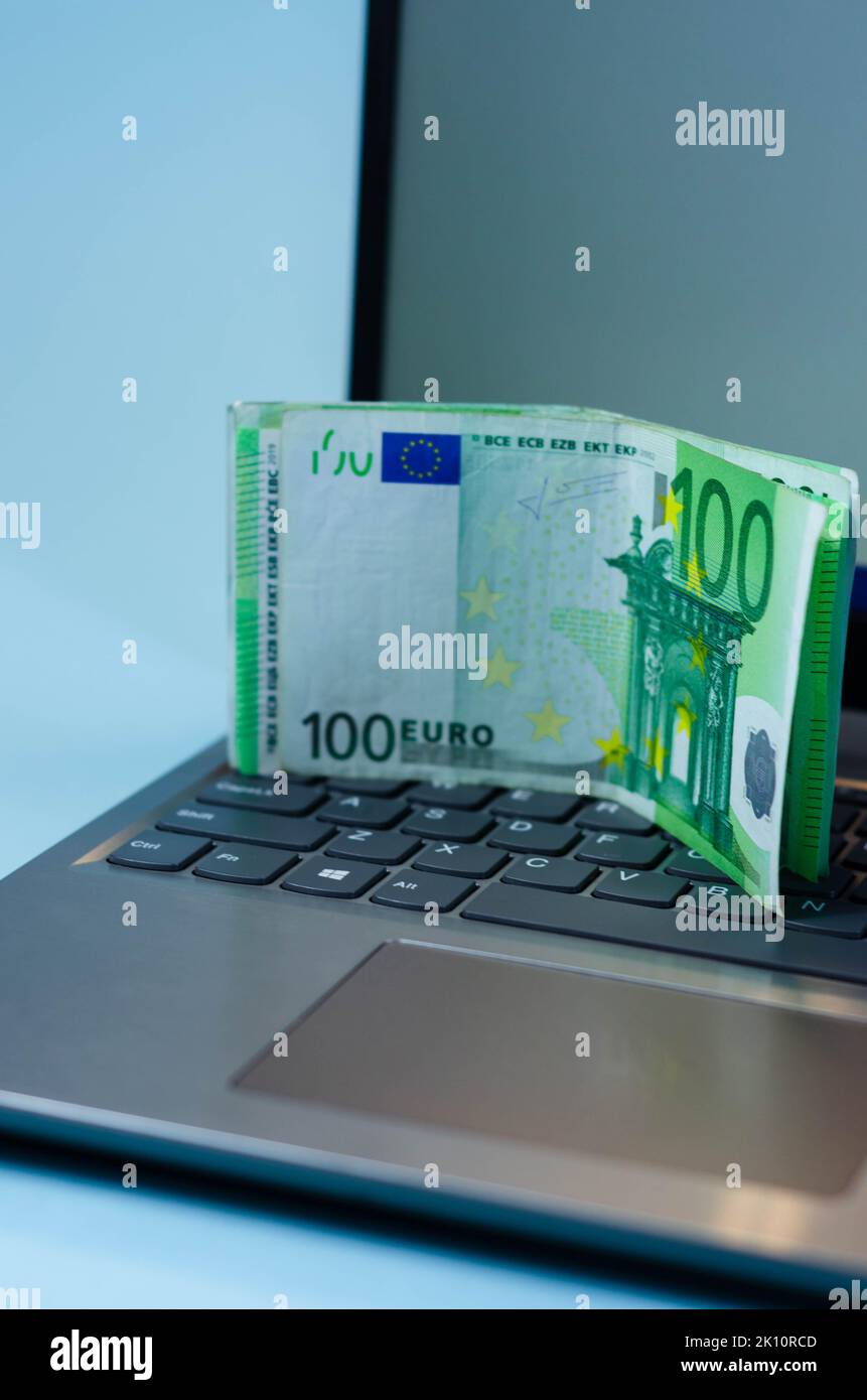 Stack pile of 100 50 Euro bank currency notes above the keyboard of ...