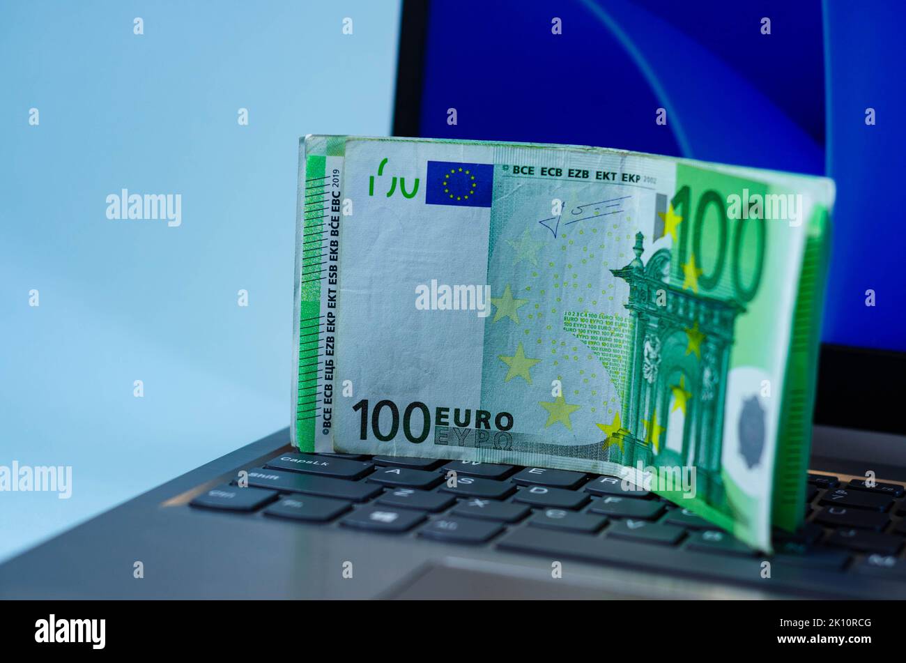 Stack pile of 100 50 Euro bank currency notes above the keyboard of ...