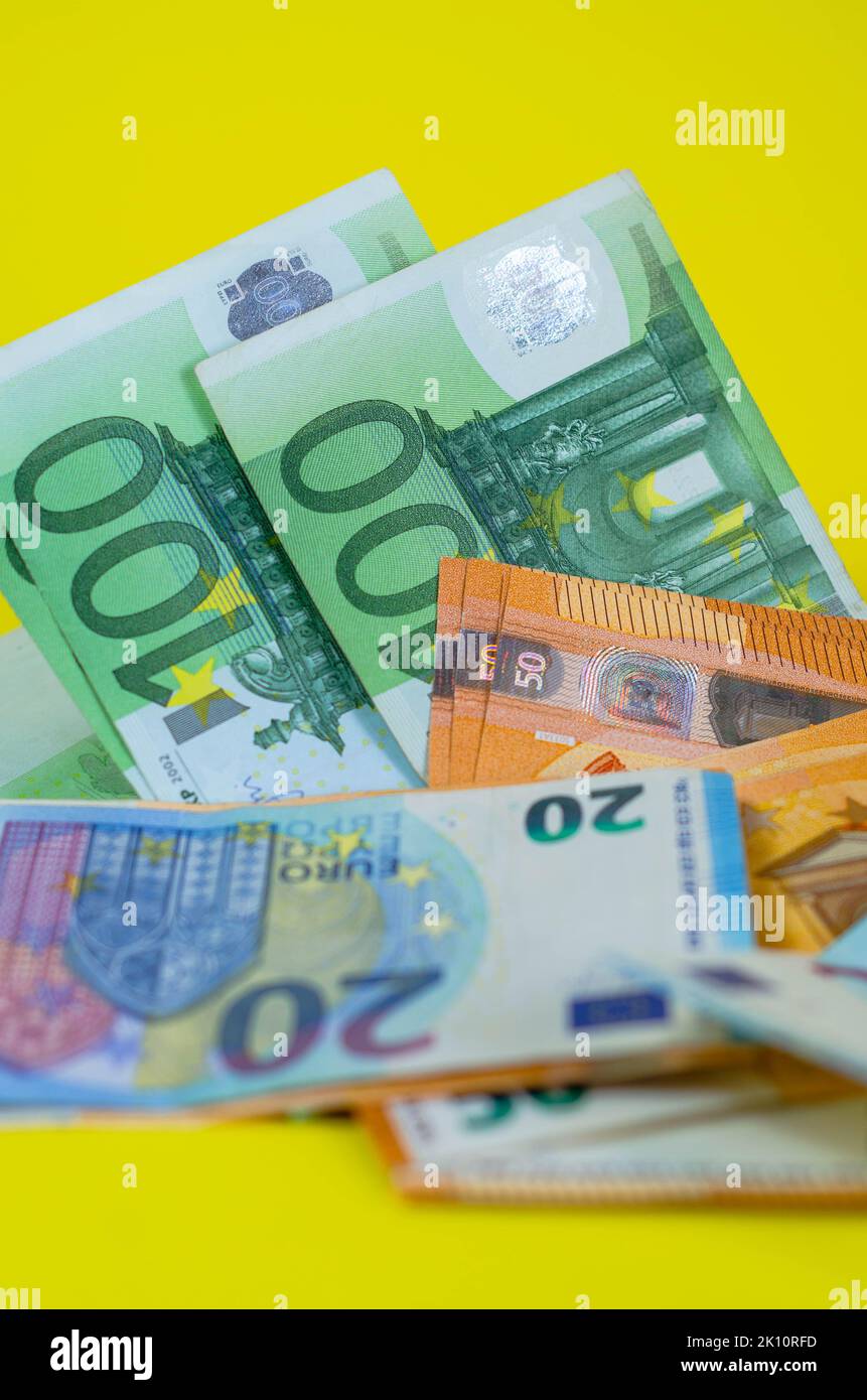 Euro banknotes on yellow background. Money and finance Stock Photo - Alamy