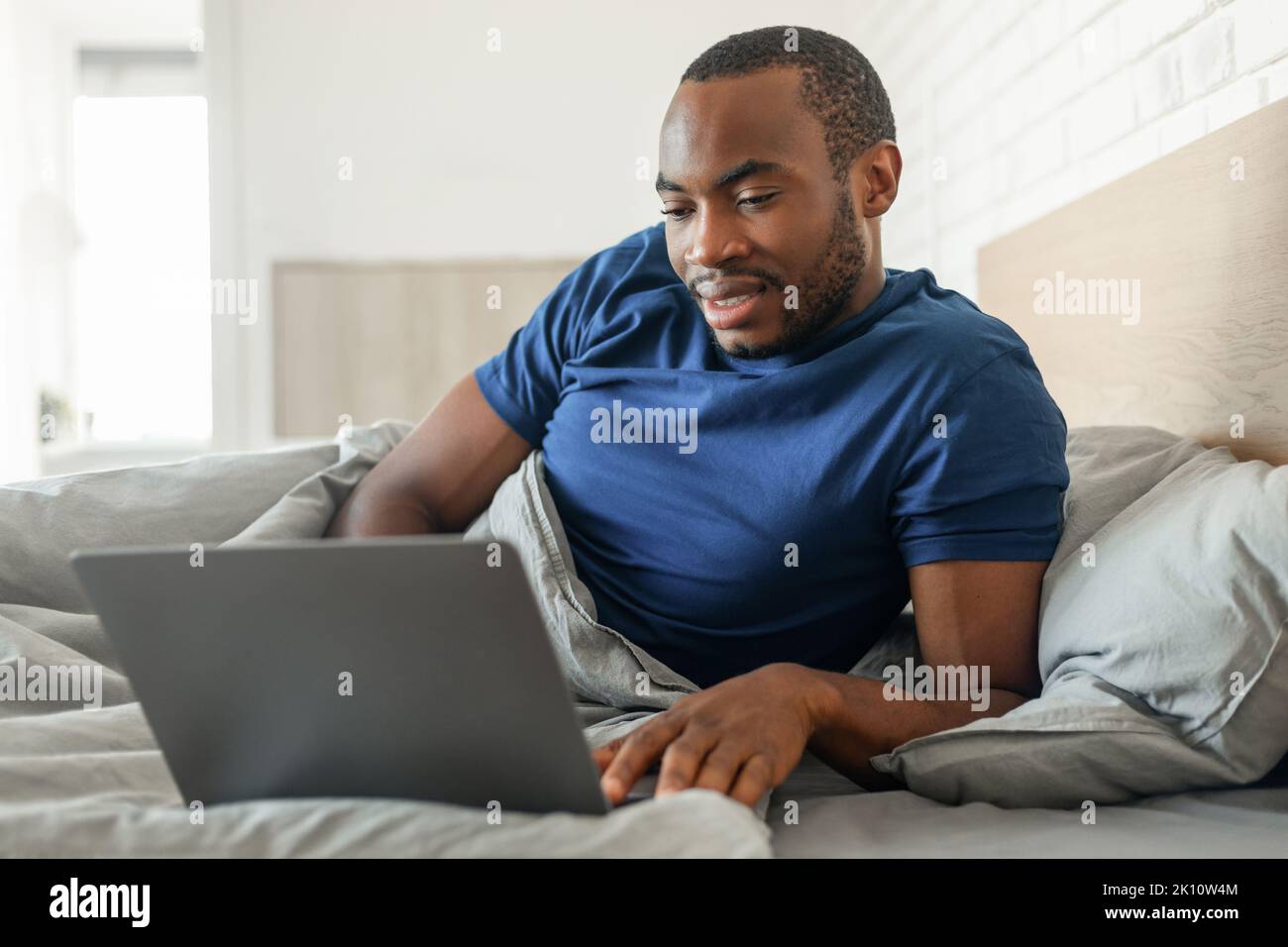 Man typing laptop lying in hi-res stock photography and images - Alamy