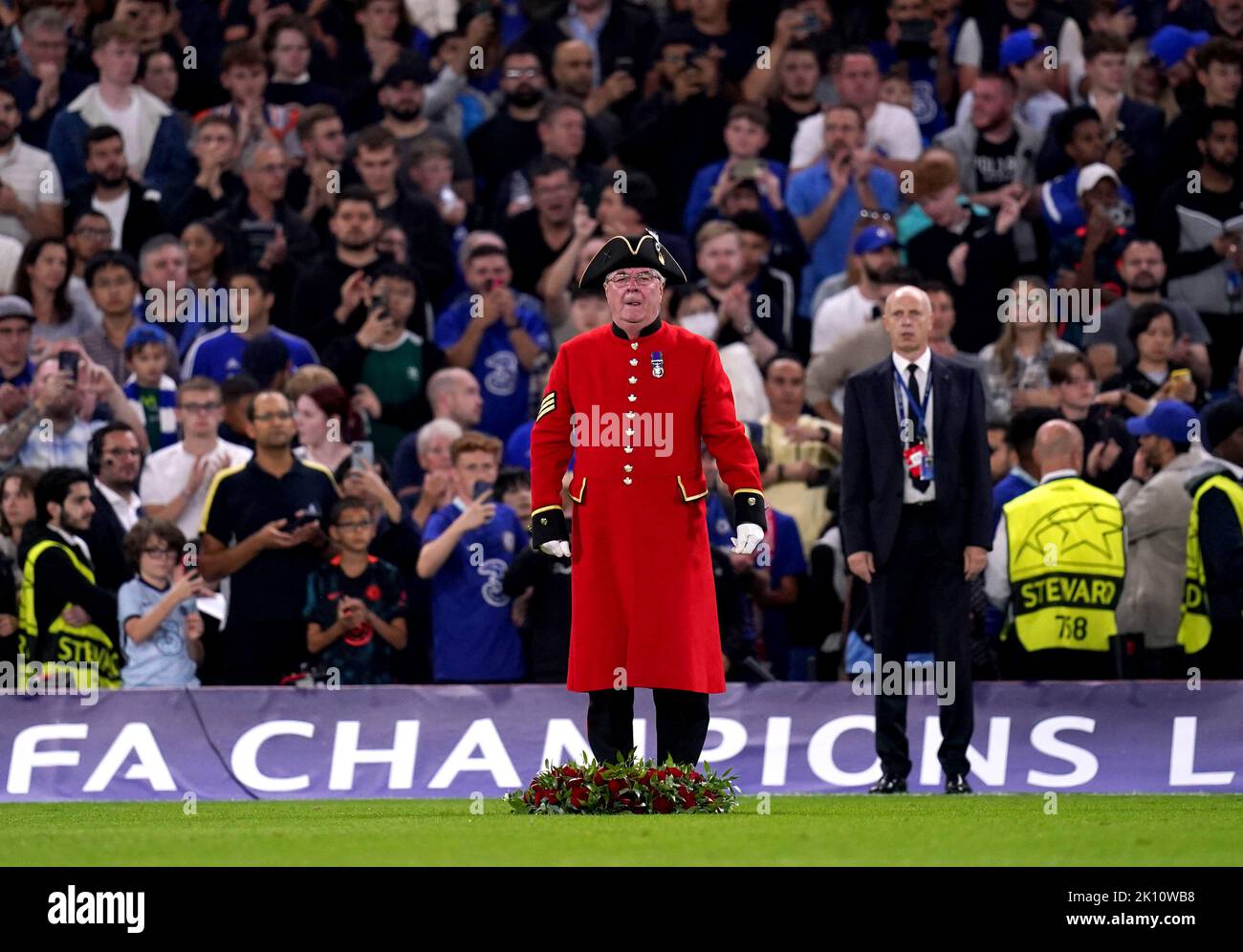 A Chelsea pensioner lays a wreath on the pitch as a tribute to Queen ...