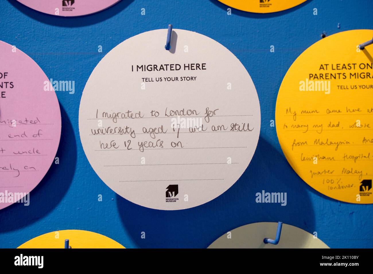 individual immigration story written on a paper discs at migration ...