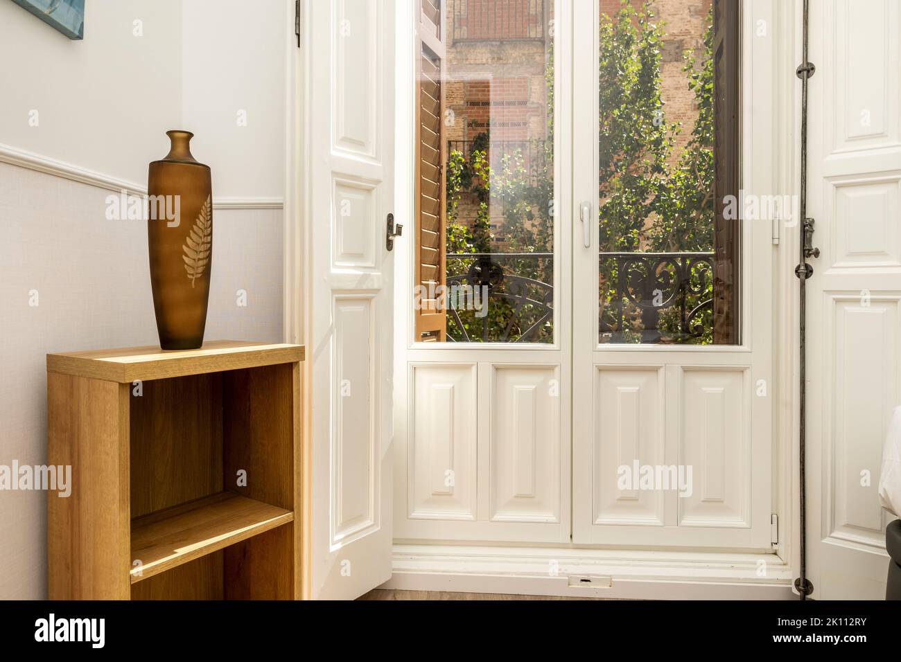 Room with a stained glass window on the balcony and wooden furniture ...