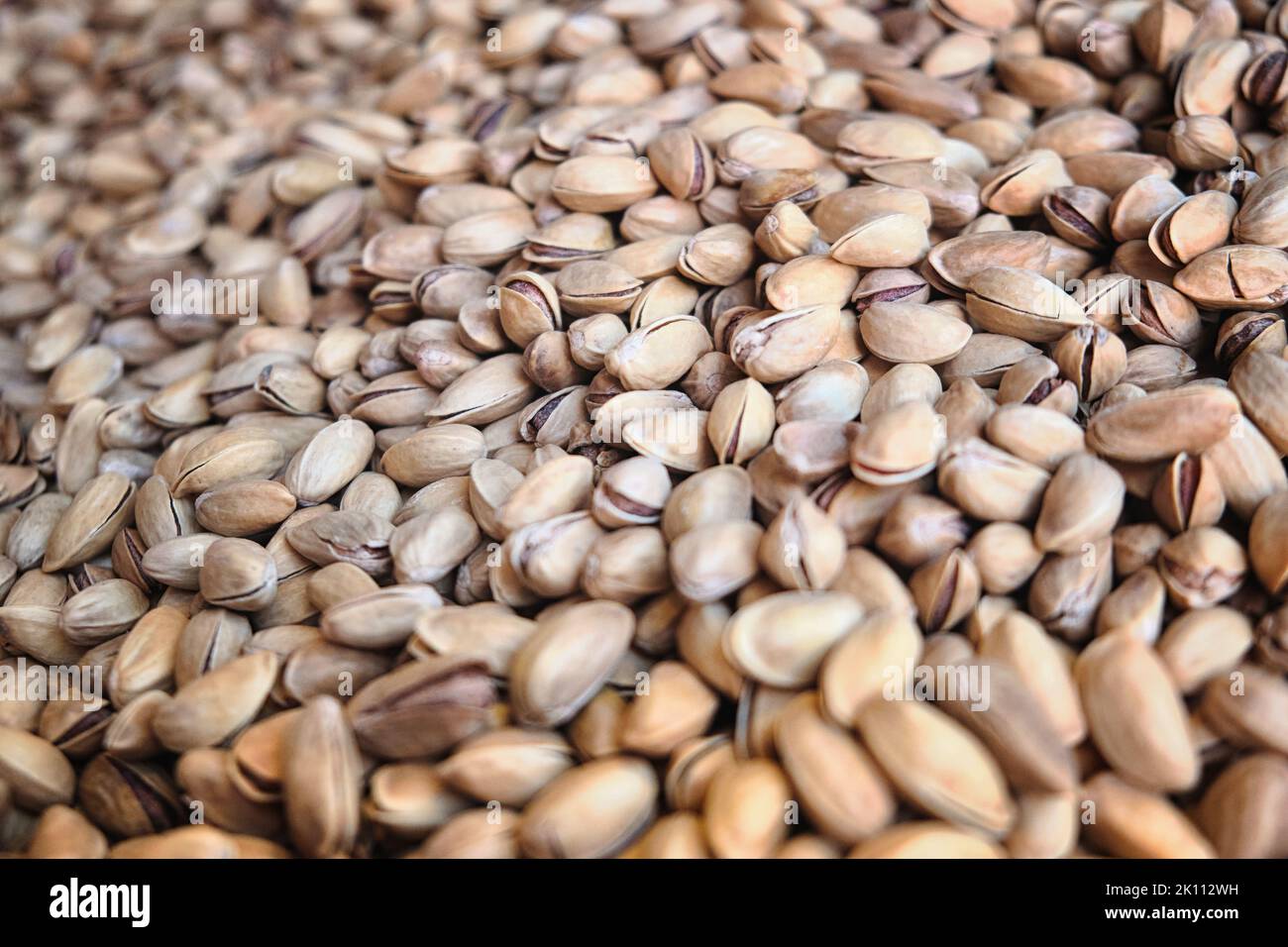 Pistachios in a nut shell background Stock Photo - Alamy