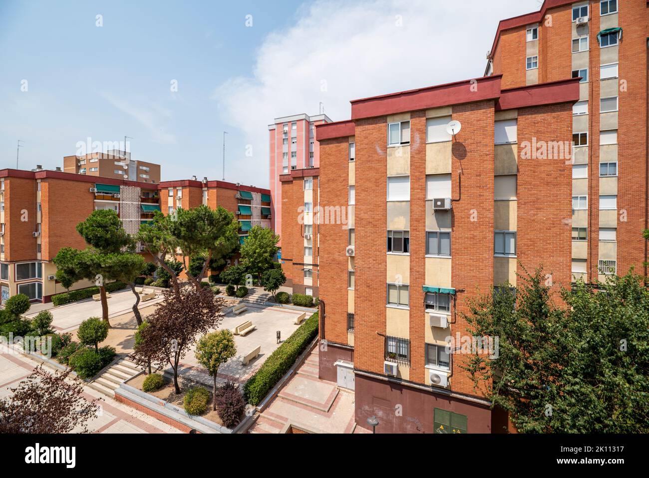 Facades of urban residential buildings with beautiful gardens in common ...