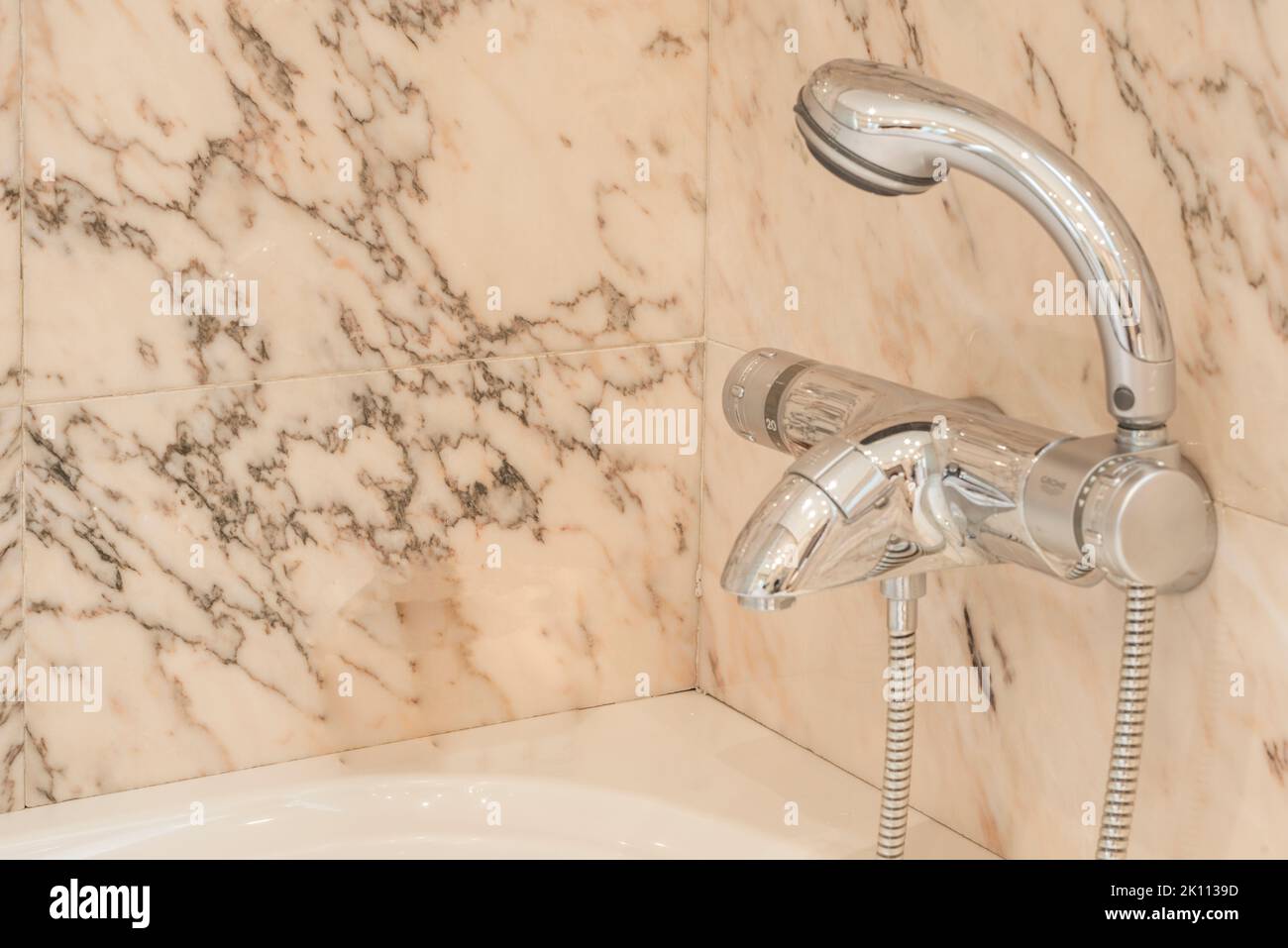 Stainless steel water temperature and flow taps in the corner of a ...