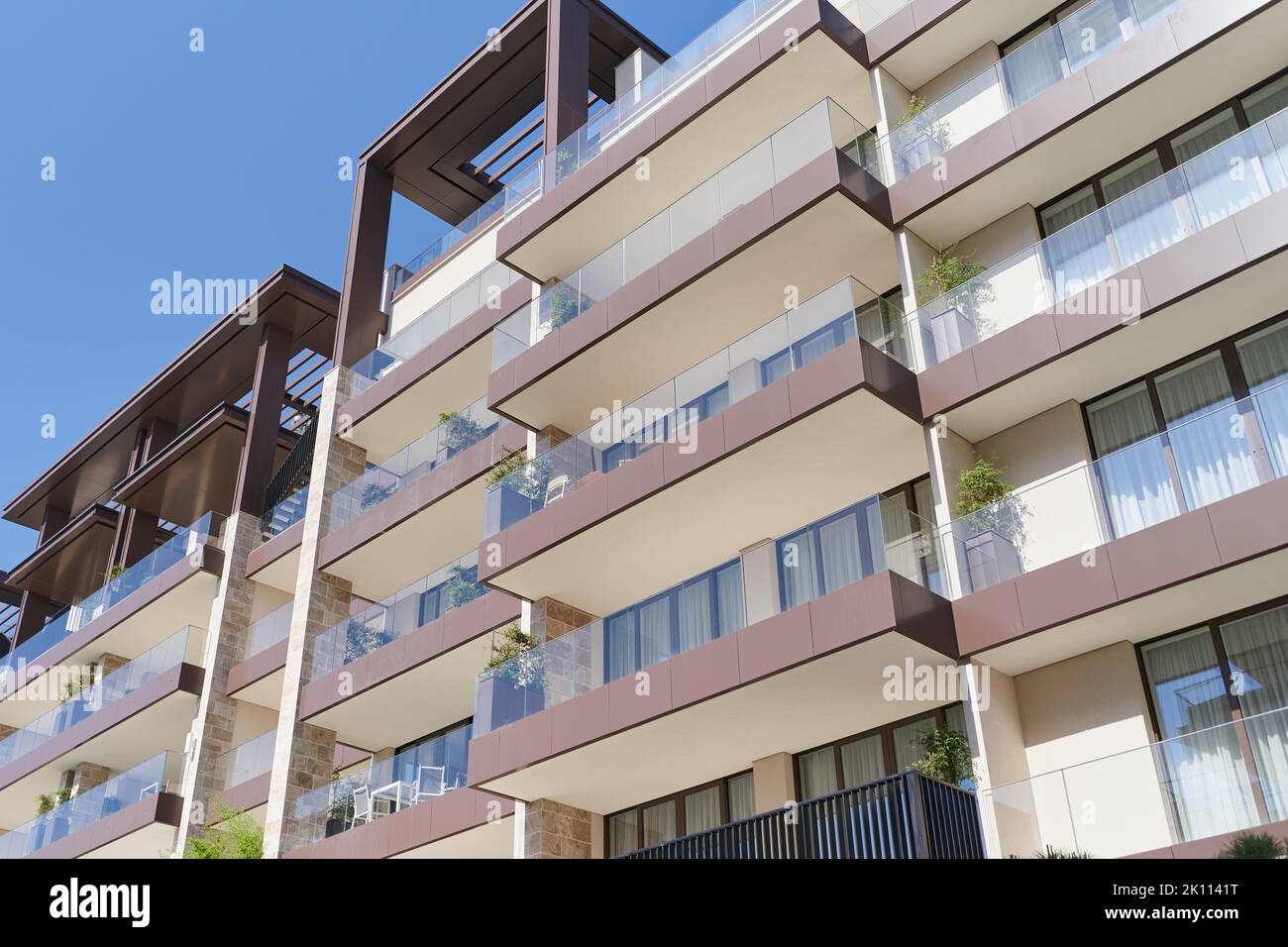 Modern apartment building with glass railing balcony Stock Photo - Alamy