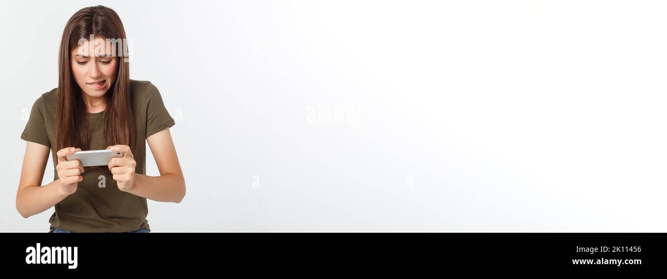 Happy attractive brunette girl joying win in video game on smartphone ...