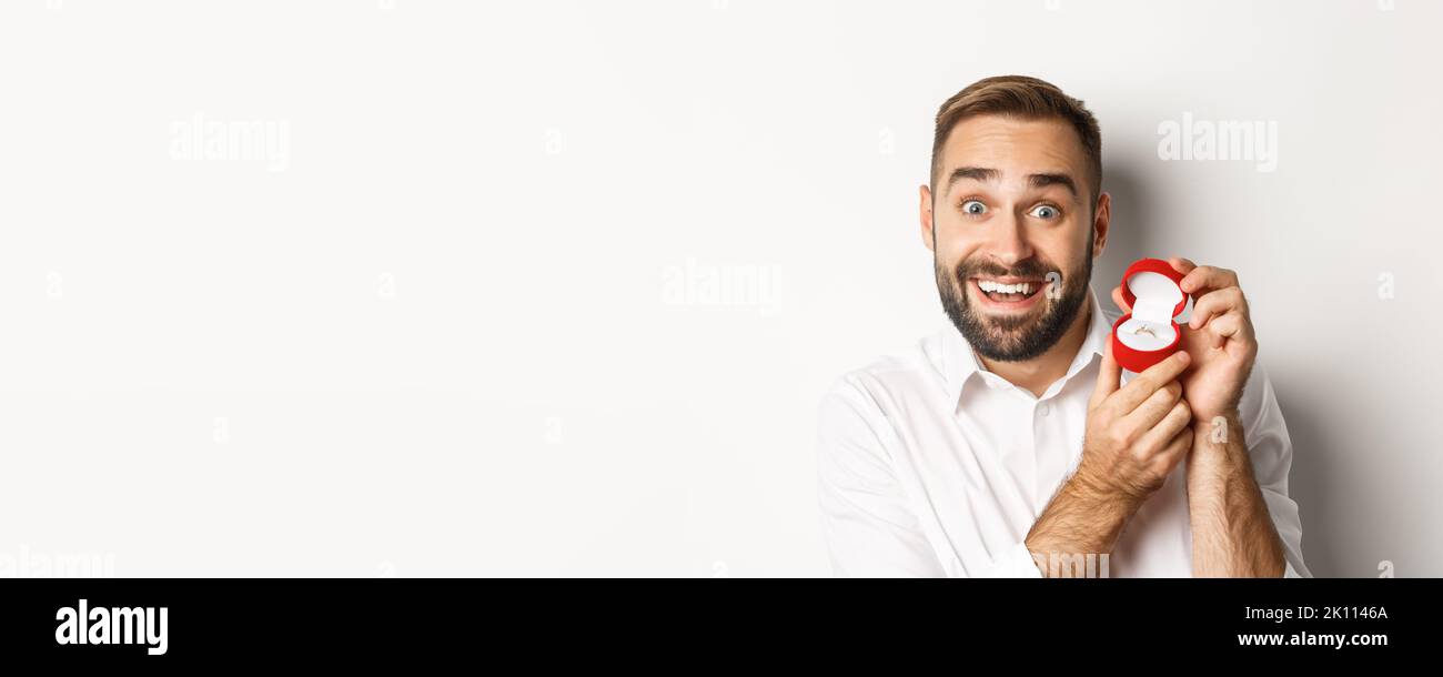 Close-up of handsome guy making proposal, looking hopeful and showing ...