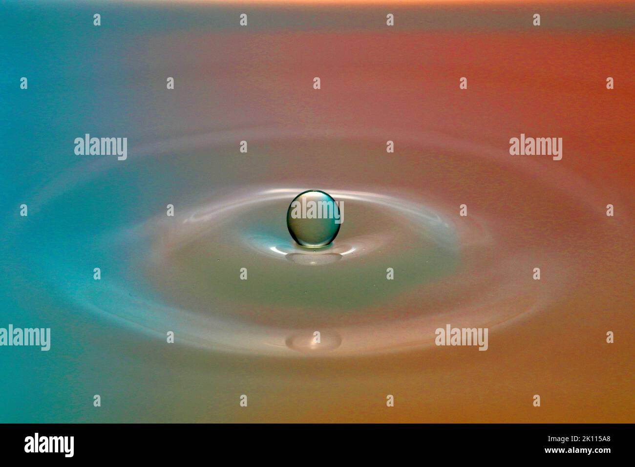 A drop falls into the water and creates great shapes Stock Photo - Alamy