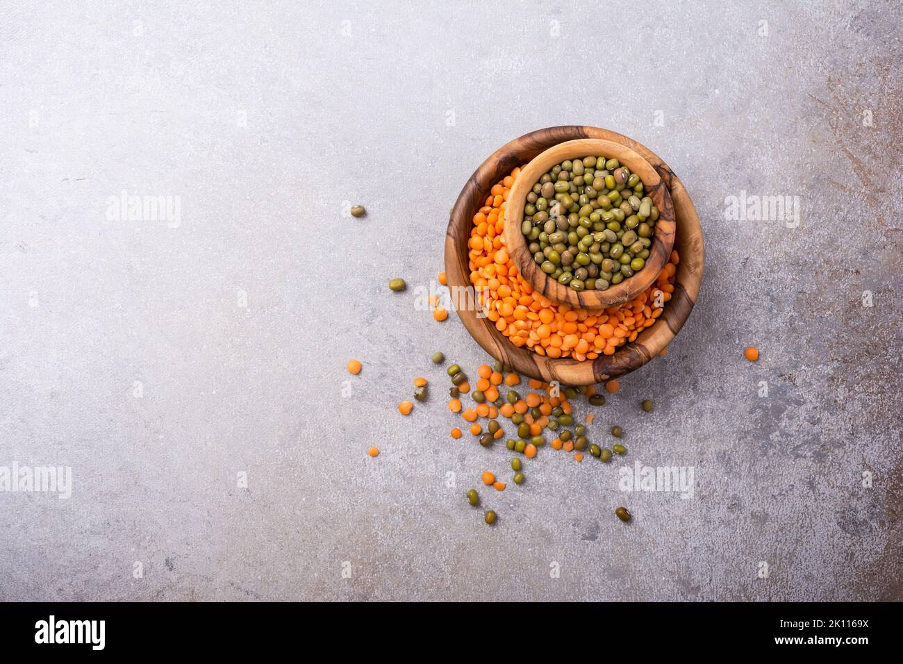Top view of orange lentils and green mung in wooden bowls for tasty ...