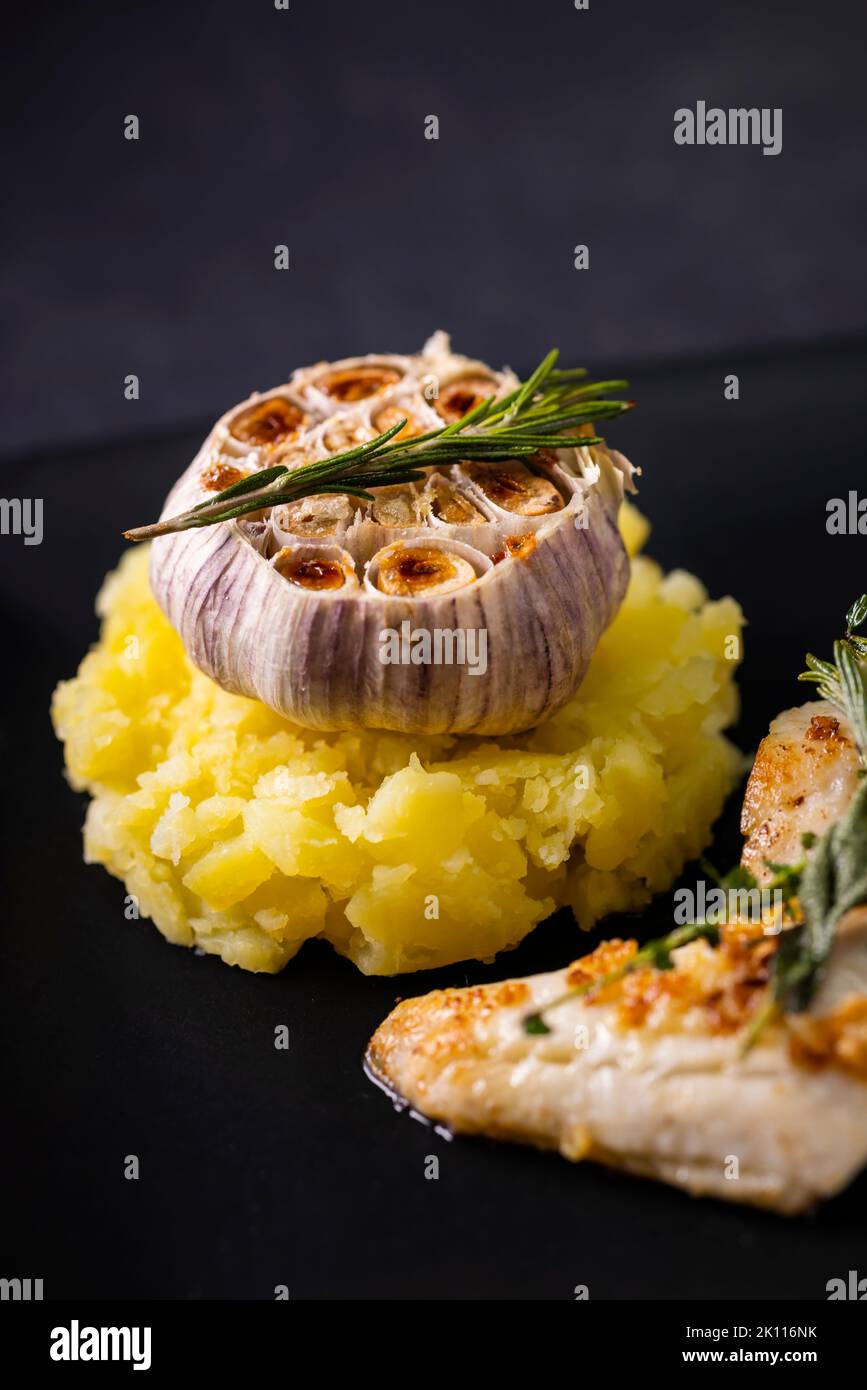 cod fillet with couscous and roasted garlic Stock Photo - Alamy