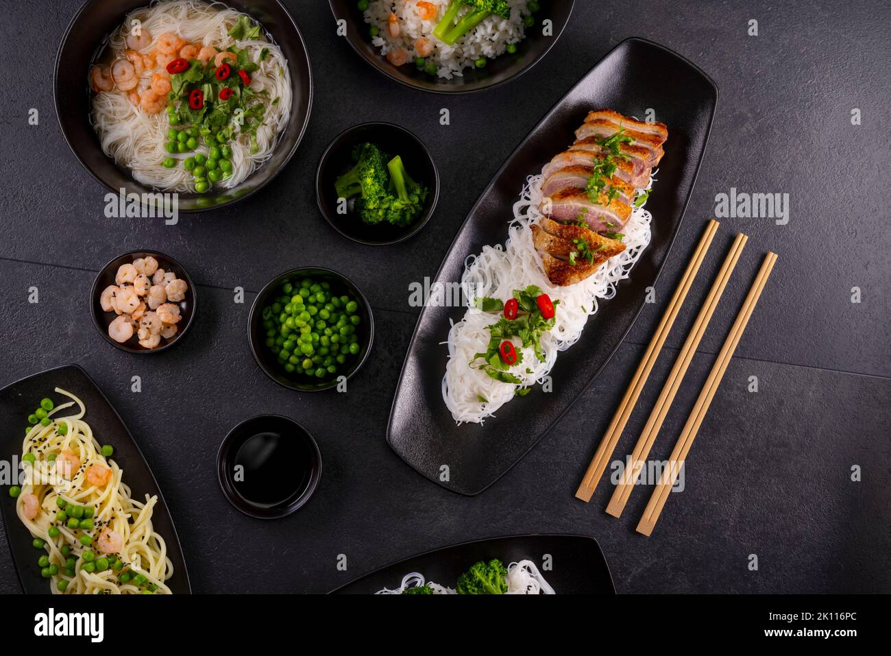 Various dishes of Asian cuisine with different types noodles and rice ...