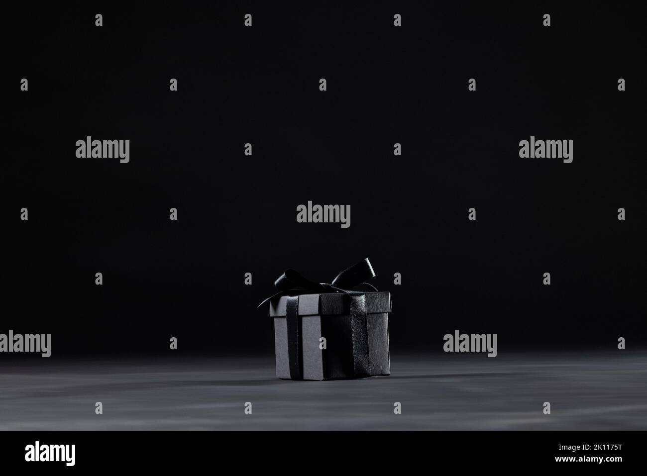 Composition of present with black ribbon on gray background Stock Photo ...
