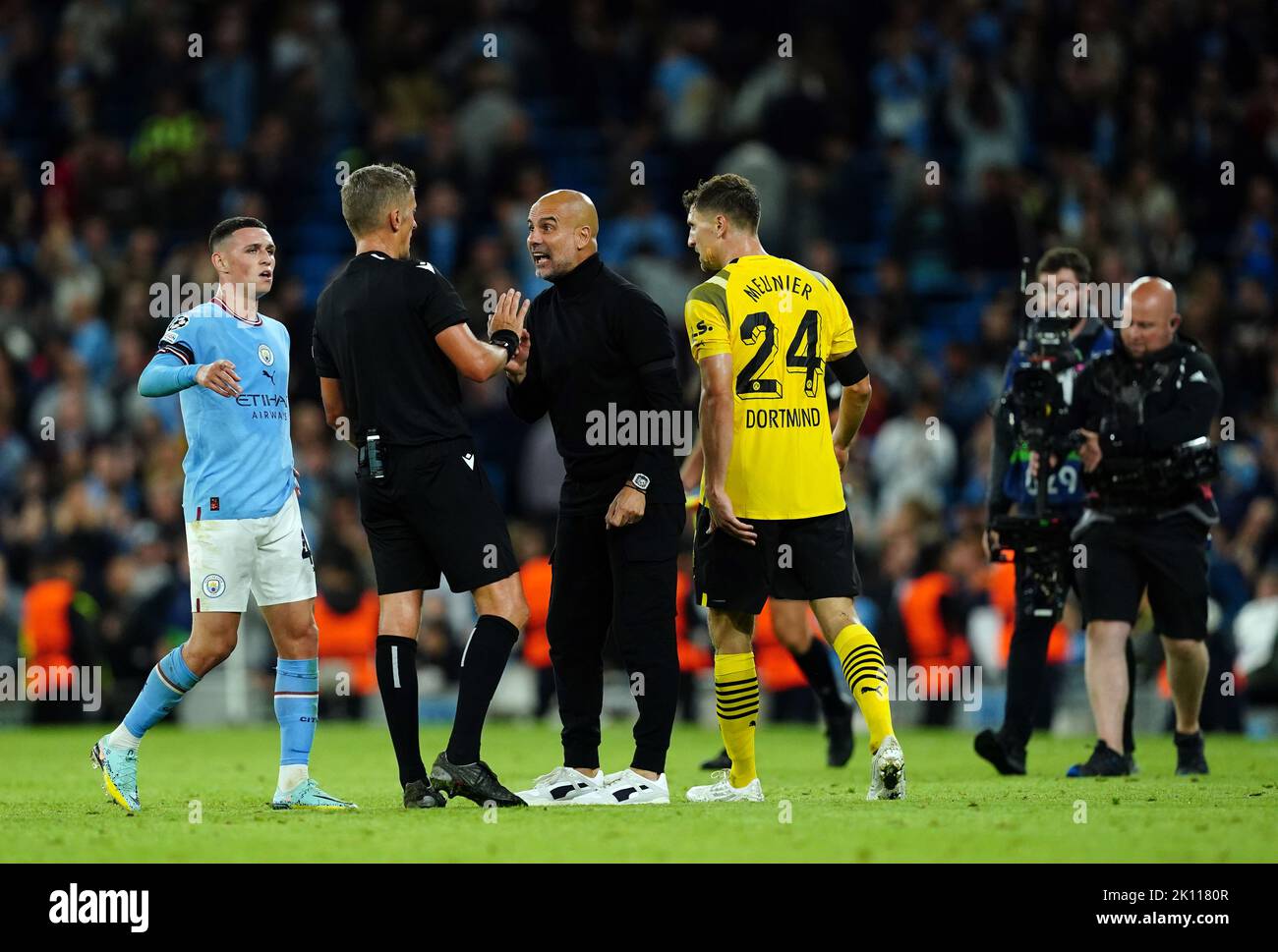 Manchester City manager Pep Guardiola speaks to an official following ...