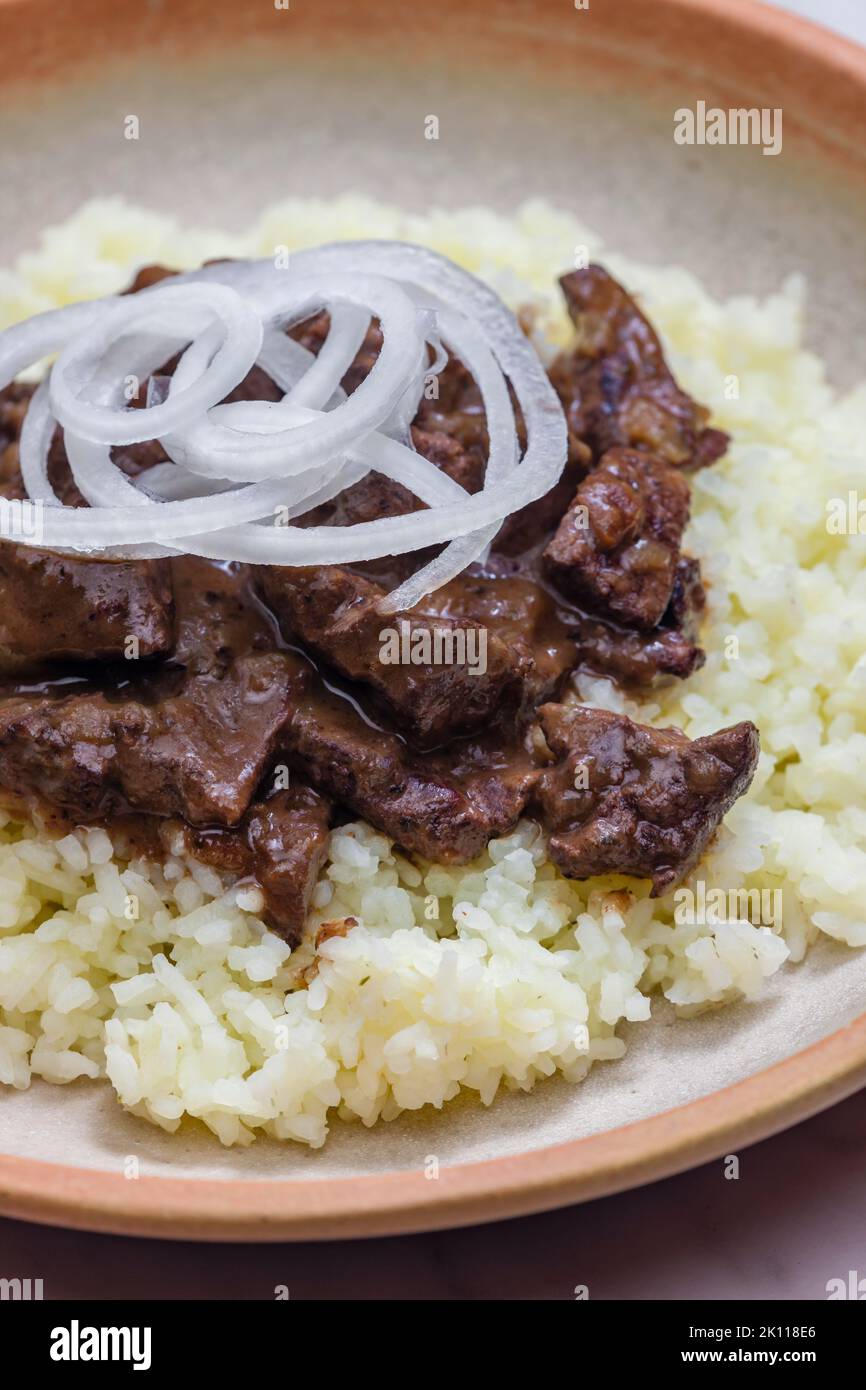 beef stew with rice and onion rings Stock Photo - Alamy