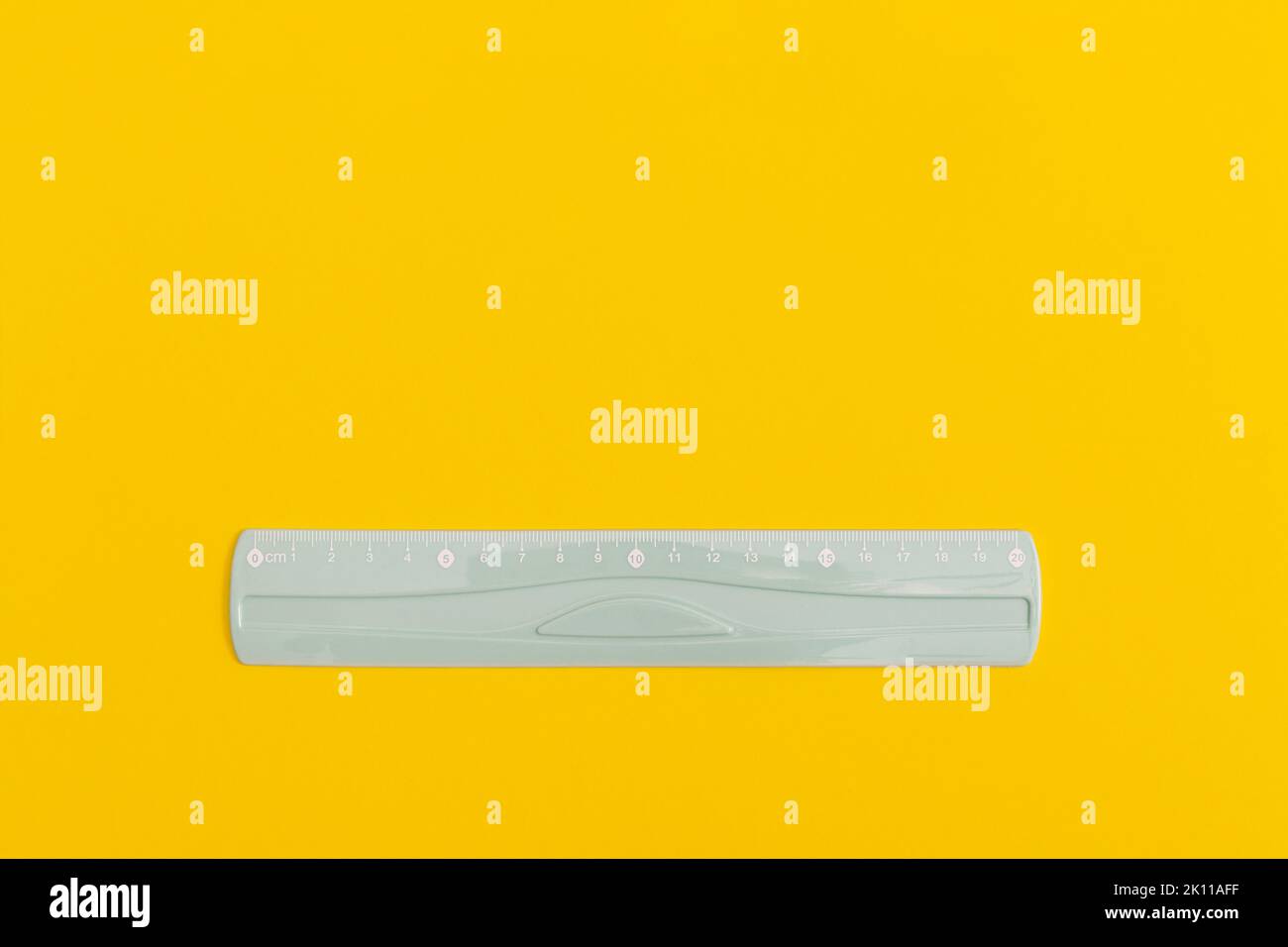 School black ruler on yellow background. Top view with copy space. Flat ...