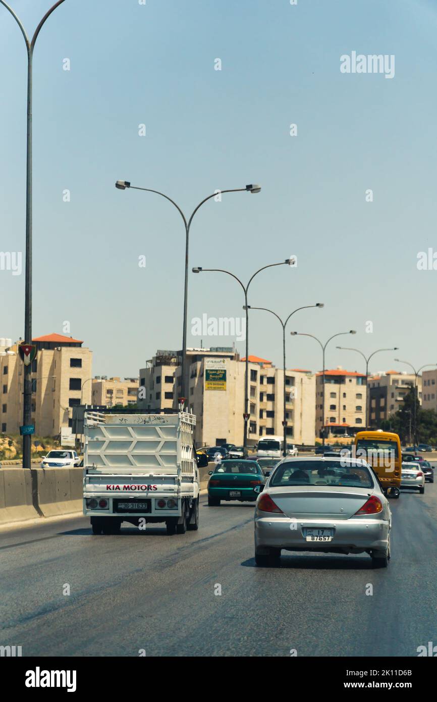 06.18.2022. Amman, Jordan. Cars moving on the main road and buildings ...