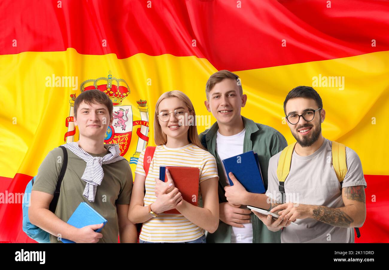 Group of students against flag of Spain. Concept of studying Spanish ...