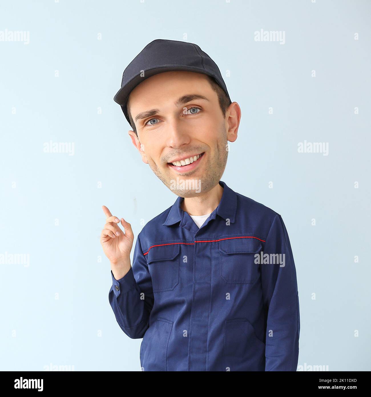 Funny car mechanic with big head pointing at something on light ...
