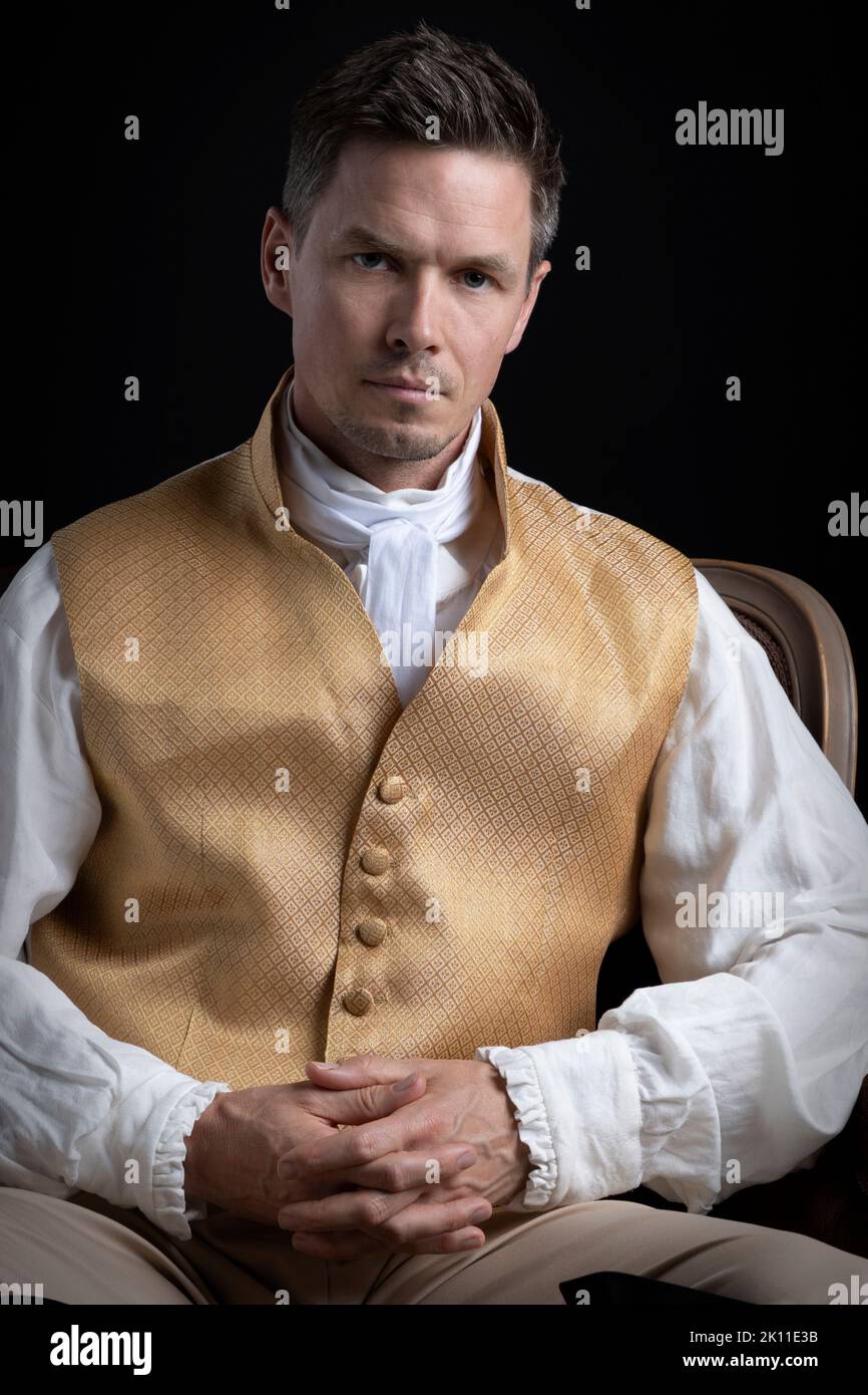 A Regency gentleman wearing a gold waistcoat and breeches Stock Photo ...