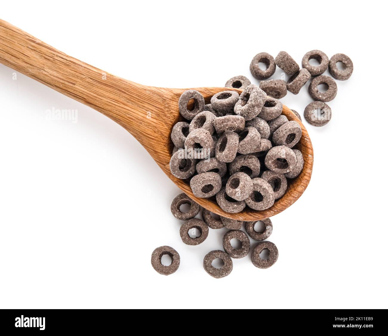 Wooden spoon with black cereal rings on white background Stock Photo ...