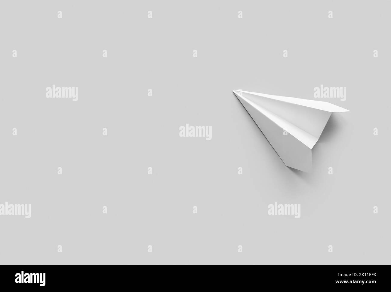 White paper plane on light background Stock Photo - Alamy
