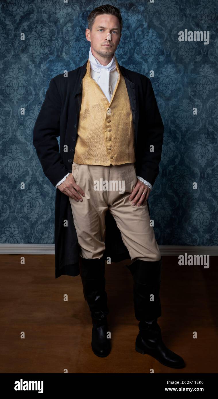 A Regency gentleman wearing a gold waistcoat and breeches Stock Photo ...