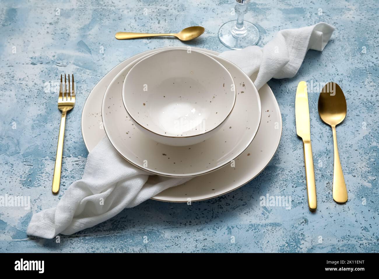 Simple dinnerware on blue table Stock Photo - Alamy