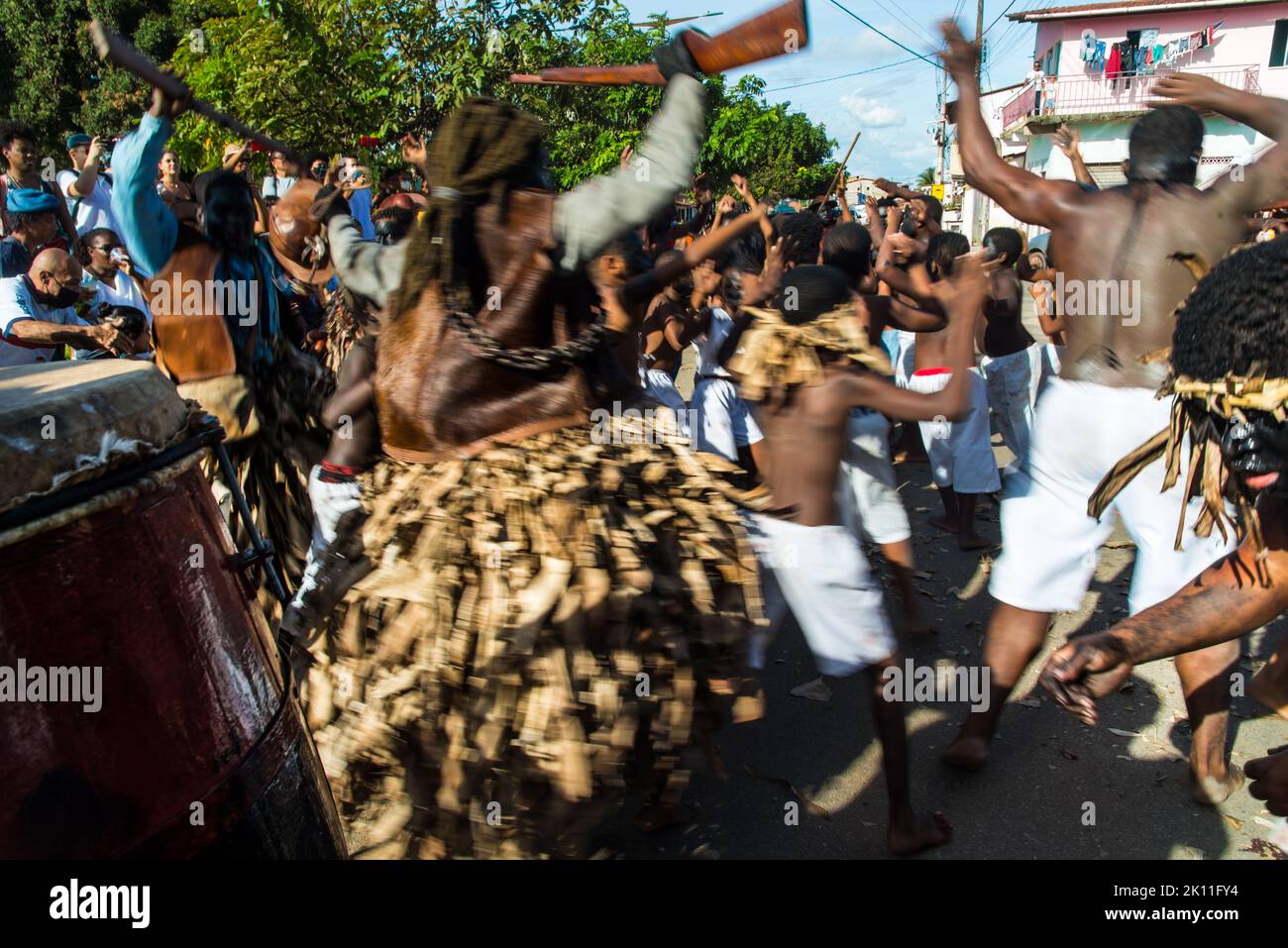 Members of the cultural event Nego Fugido sing and sit on the ground ...