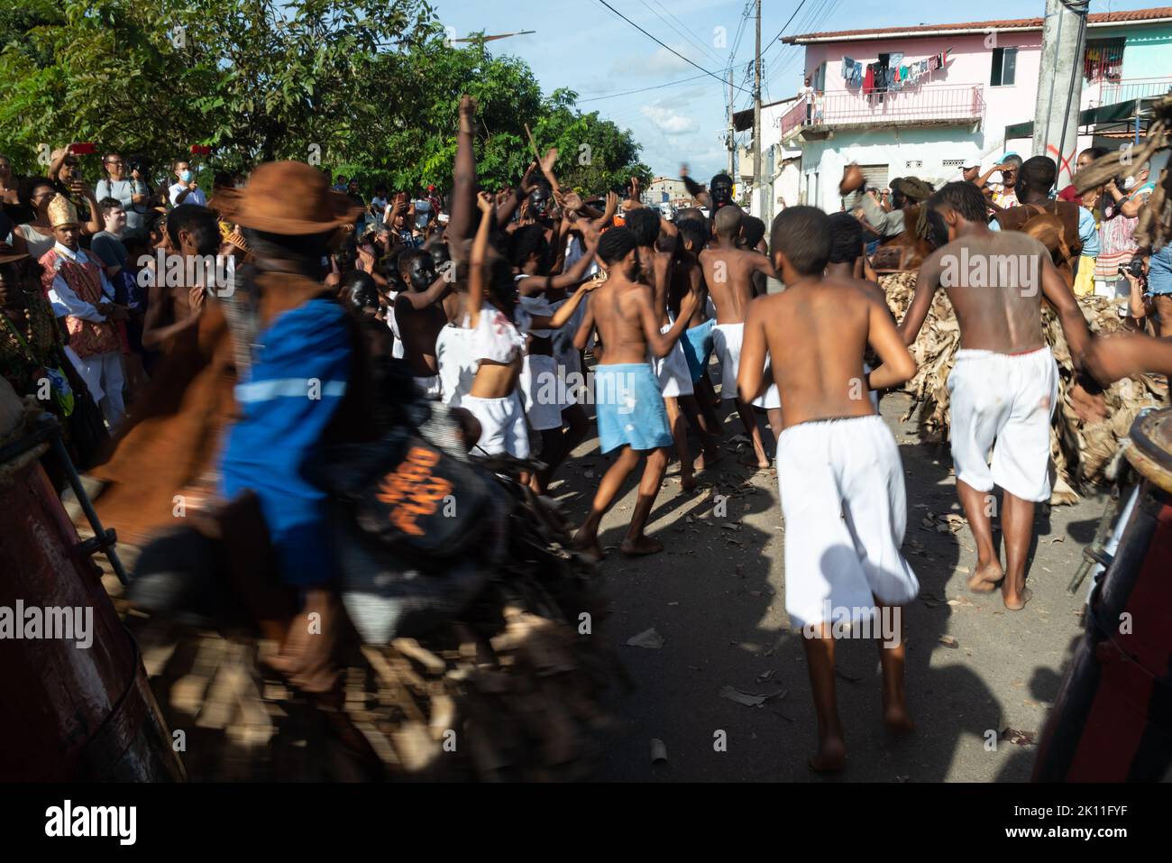 Members of the cultural event Nego Fugido sing and sit on the ground ...