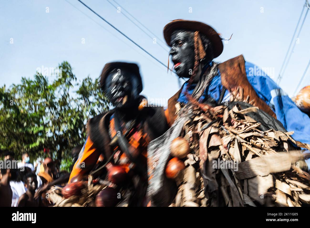 Members of the cultural event Nego Fugido sing and sit on the ground ...