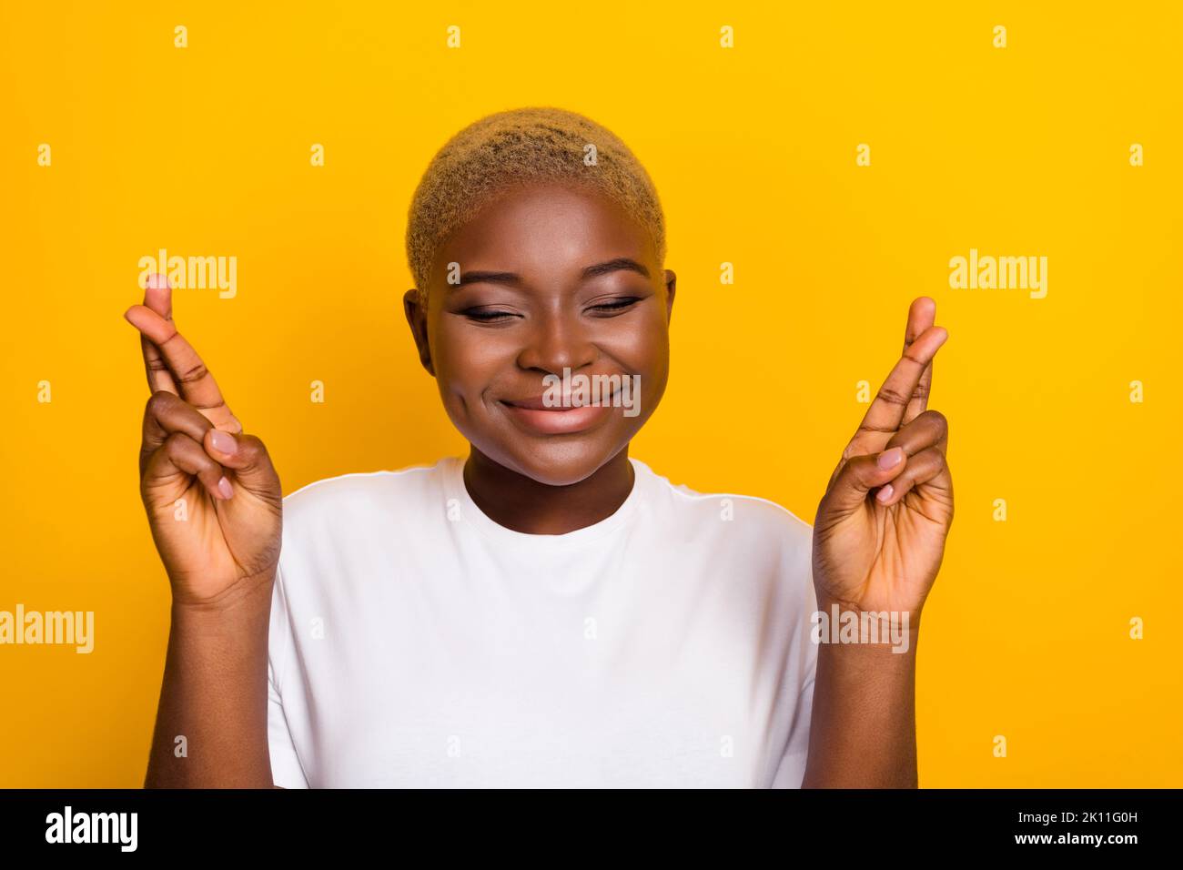 Portrait of delightful charming girl closed eyes raise hands crossed ...