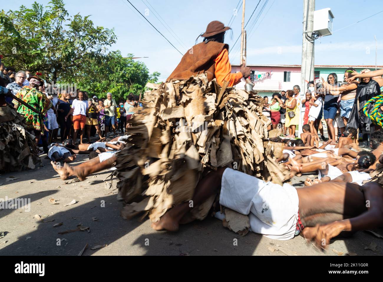Members of the cultural event Nego Fugido sing and sit on the ground ...
